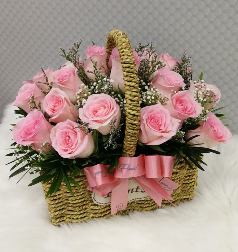Pink roses arrange in a antique basket - Blooming Florist